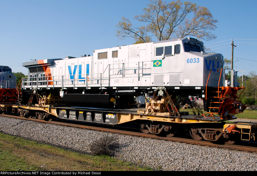 VLI BB40-9WM #6033 is one of 8 locomotives in this train heading east bound for the port of ...